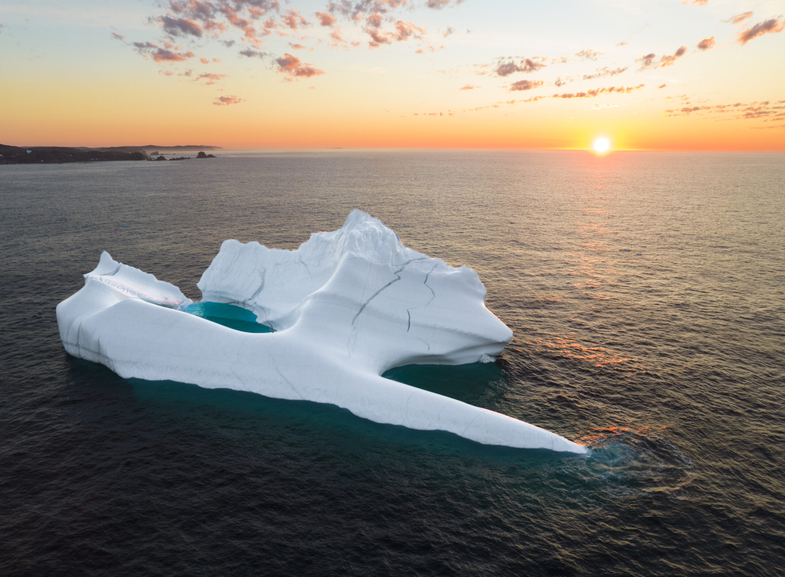 Sunrise over an iceberg in Great Brehat - Downhome Magazine