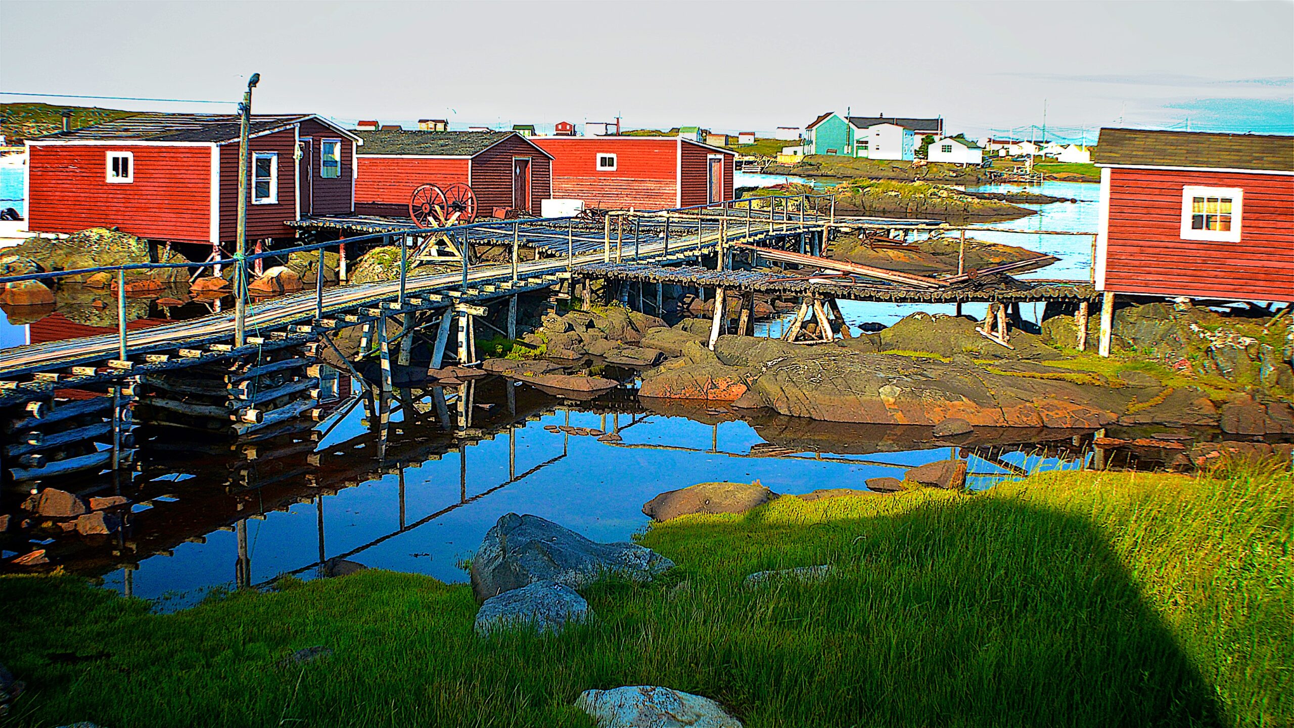 A bright sunny day highlights the colourful fishing stages on Fogo ...
