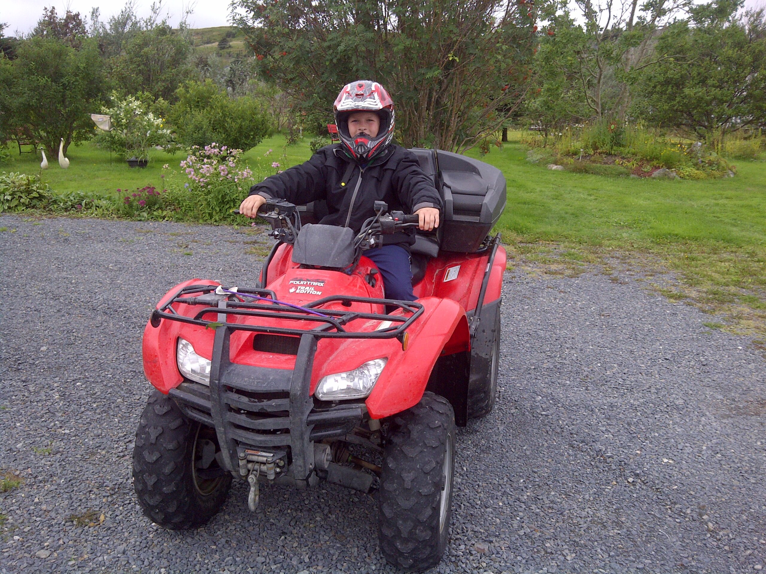 Cale on ATV in the Gulch - Downhome Magazine